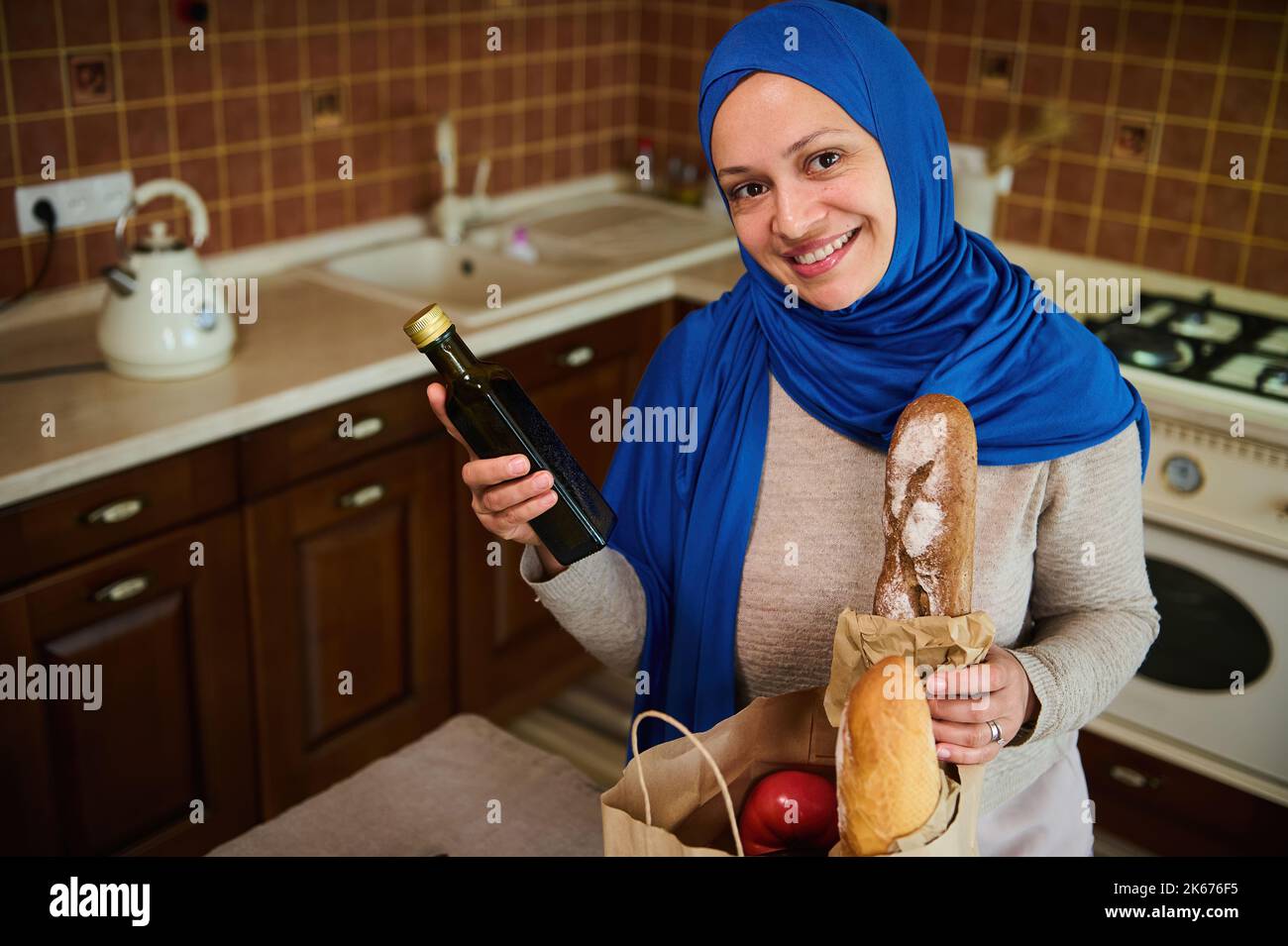 Charming Arab Muslim woman in blue hijab, sorting vegetables from ...