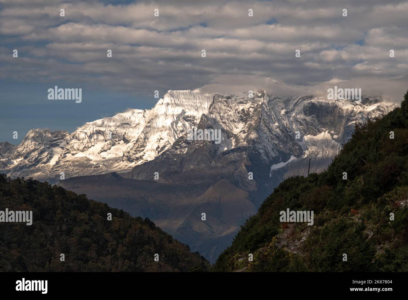Snow capped mountains in the distance looking down the valley, on the ...
