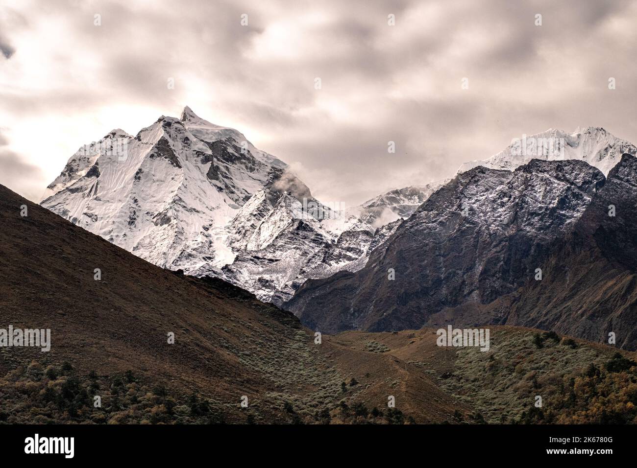 Snow capped mountains in the distance looking down the valley, on the ...