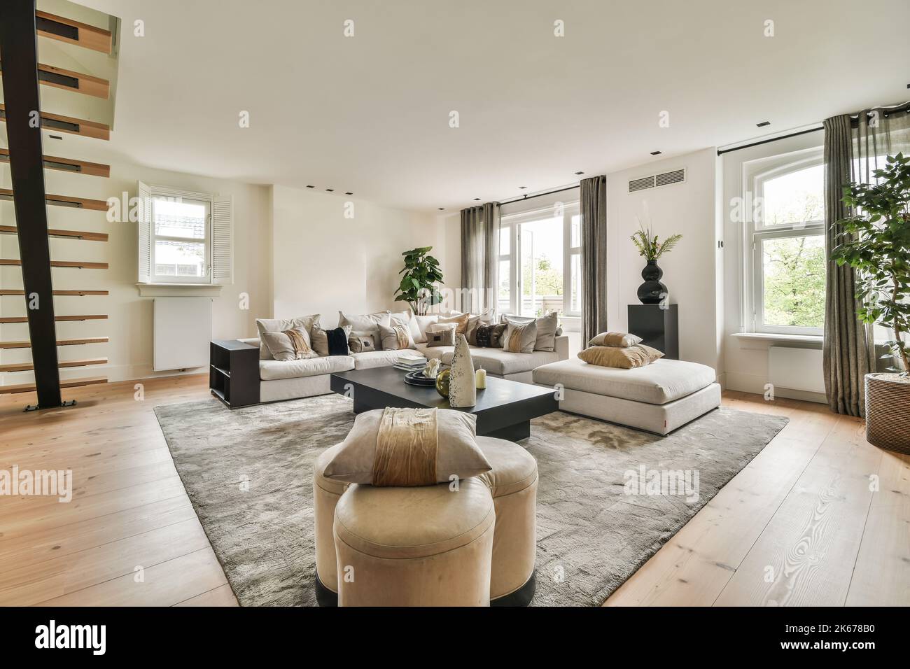 Comfortable sofa with cushions placed against light wall with TV and ...