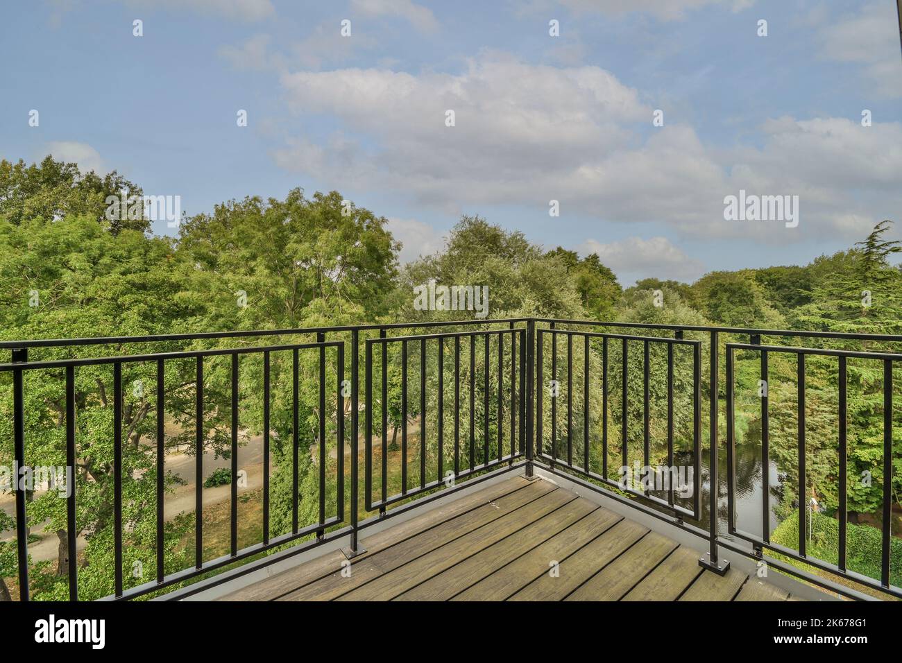 Panoramic view of old brick buildings with trees from small balcony ...