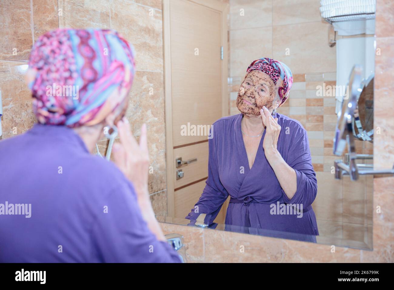 Elderly woman taking care of her face Stock Photo - Alamy