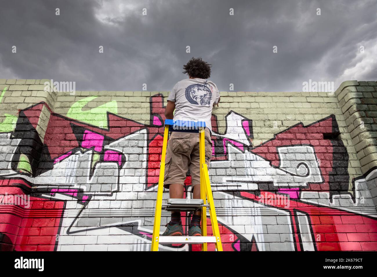 Graffiti artist at work on a wall in a city, UK 2022 Stock Photo - Alamy
