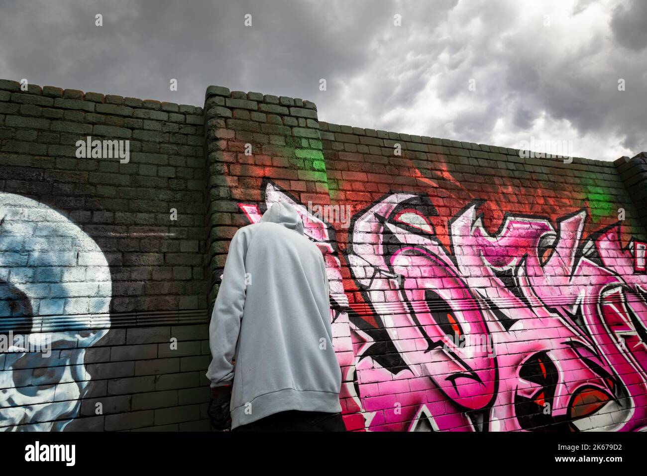 Graffiti artist at work on a wall in a city, UK 2022 Stock Photo - Alamy