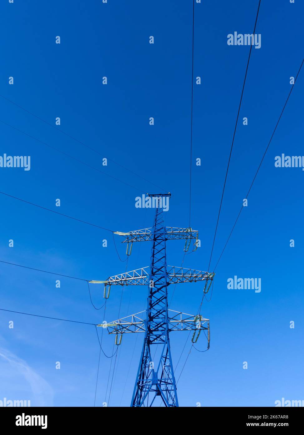 High voltage utility tower on blue sky background Stock Photo - Alamy