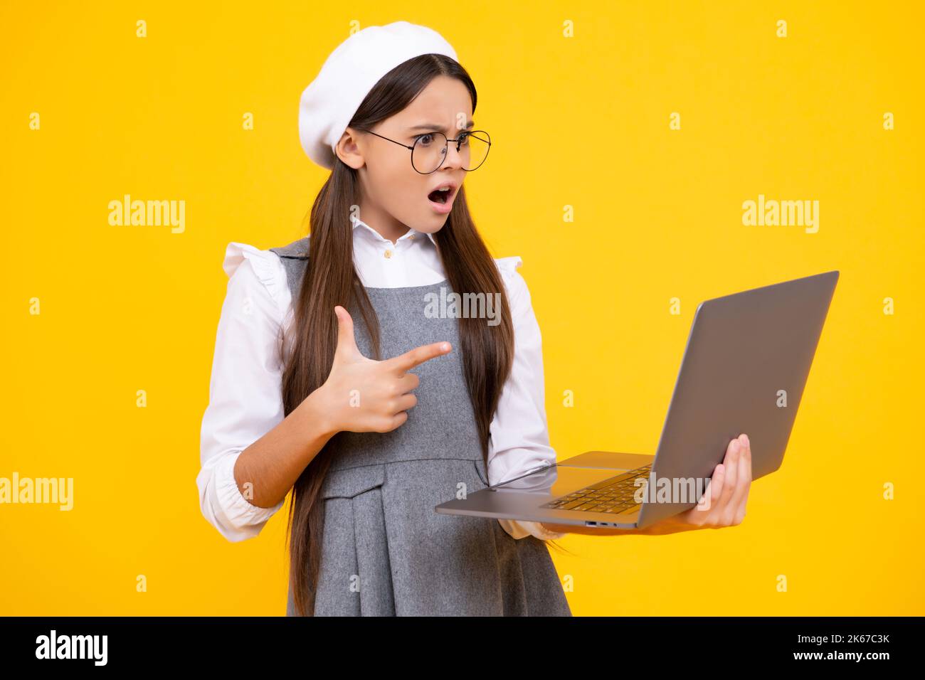Back to school, Teenager school girl with laptop computer. Angry face ...