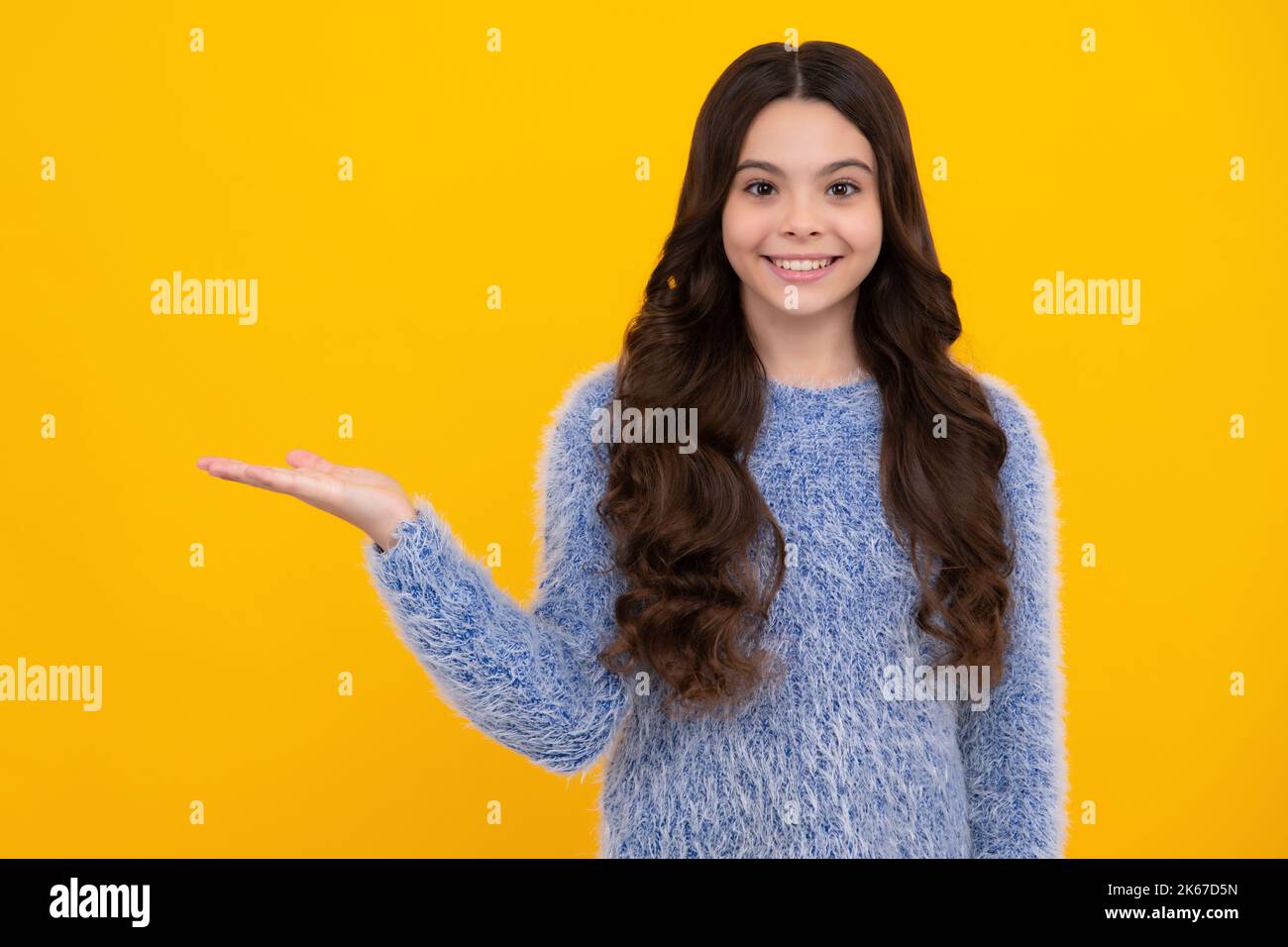 Impressed teenage girl showing recommendation copyspace. Child teenager ...