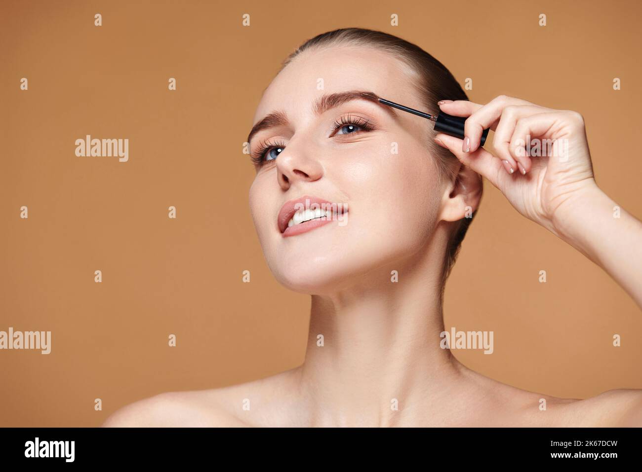 woman with perfect shape eyebrows on beige background Stock Photo - Alamy