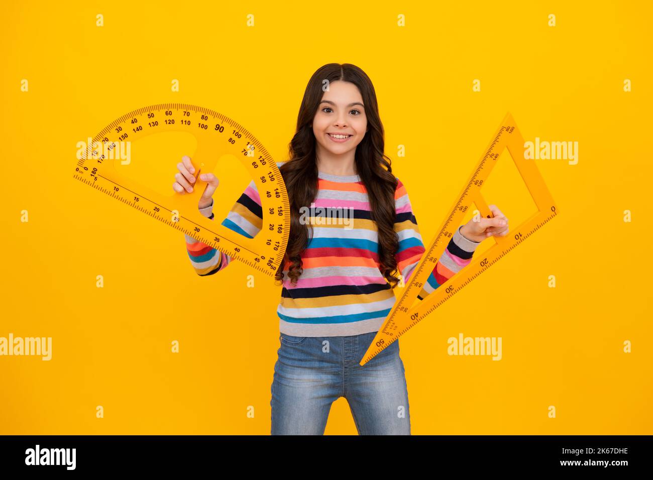 Measuring school equipment. Schoolgirl holding measure for geometry ...