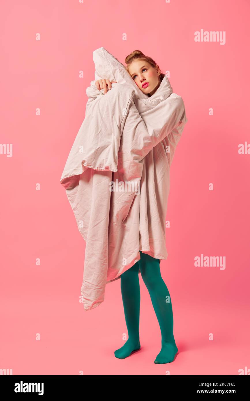 Beautiful young girl wrapped in soft blanket standing isolated over ...