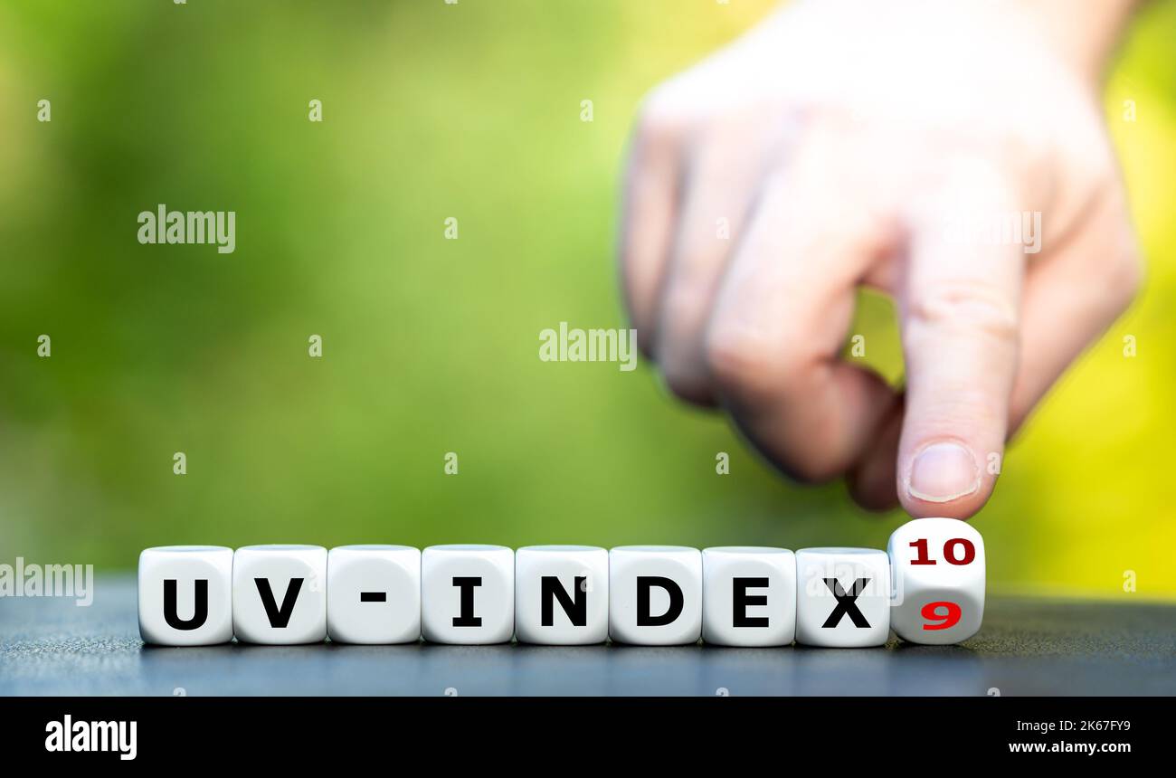 Hand turns dice and changes the expression 'uv-index 9' to 'uv-index 10 ...