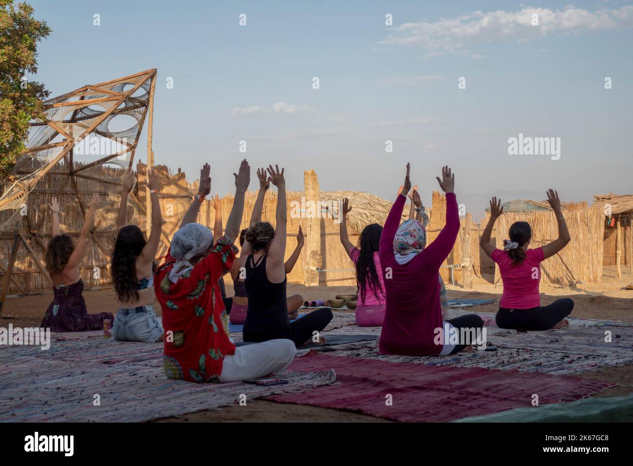 Tourists and Egyptian women practice Yoga in Ras el Satan or Ras ...