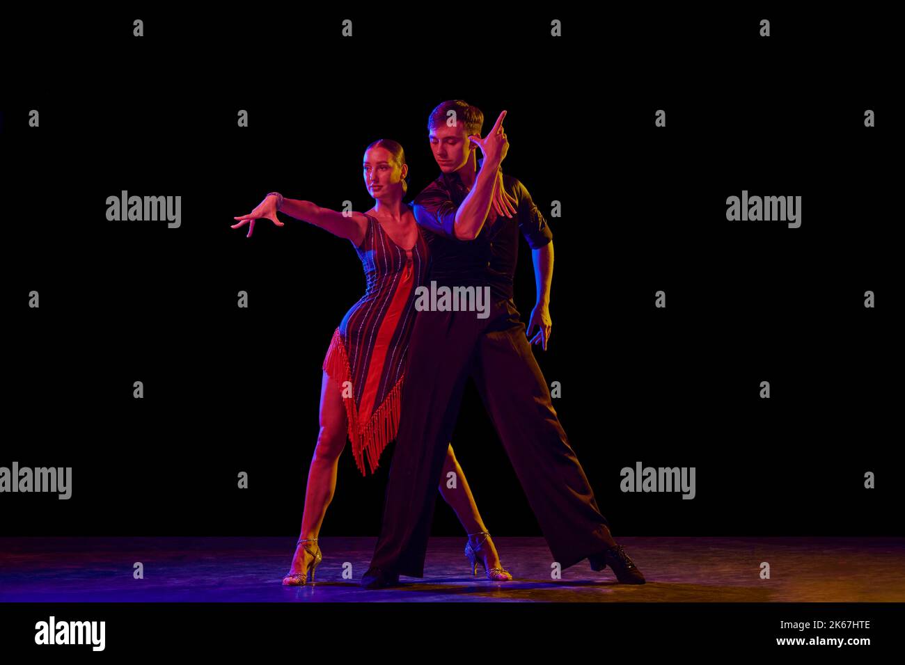 Stylish ballroom dancers couple in gorgeous outfits dancing in sensual ...