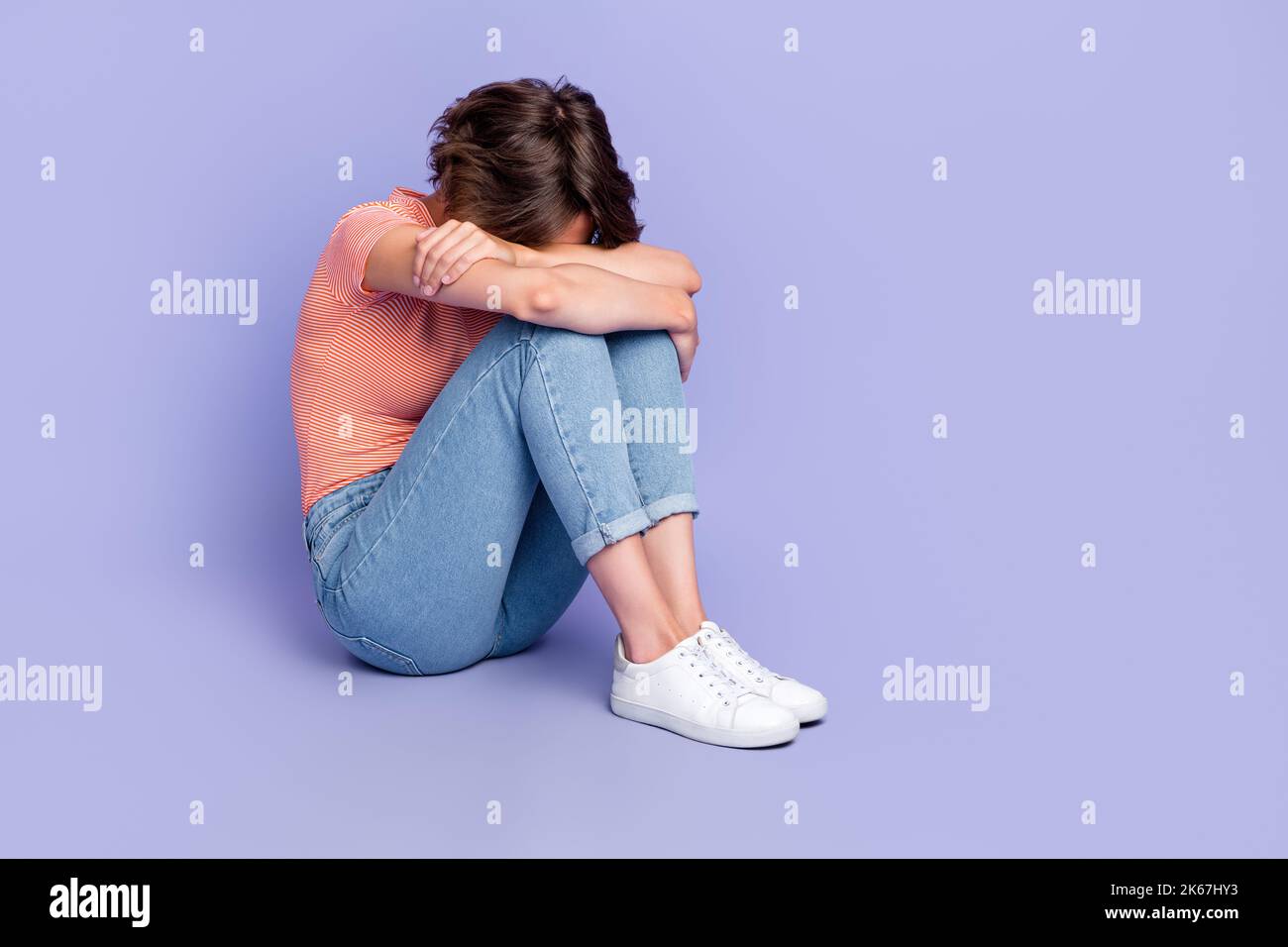 Full size photo of lovely young girl sit floor cuddle knees crying wear ...