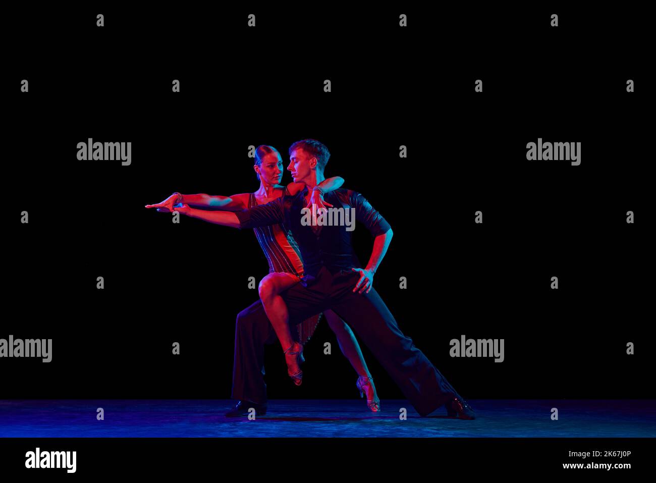 Stylish ballroom dancers couple in gorgeous outfits dancing in sensual ...