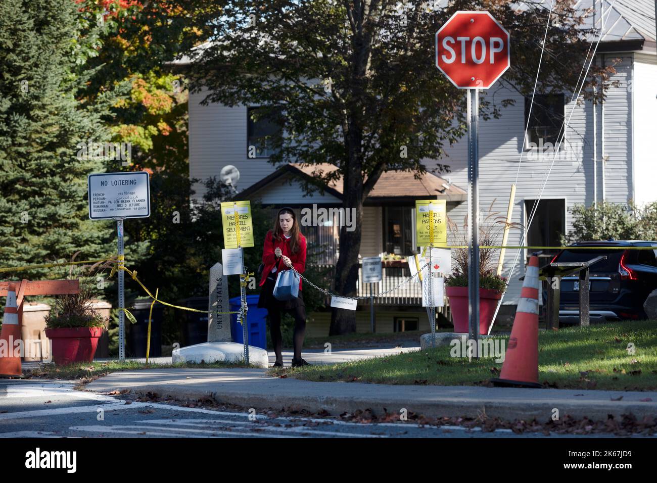 A librarian from the Haskell Library on the U.S. Canada border crosses ...