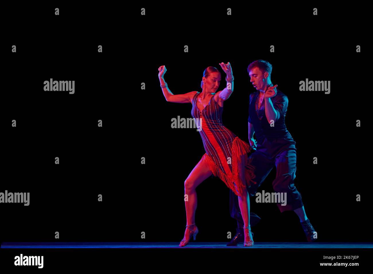 Stylish ballroom dancers couple in gorgeous outfits dancing in sensual ...