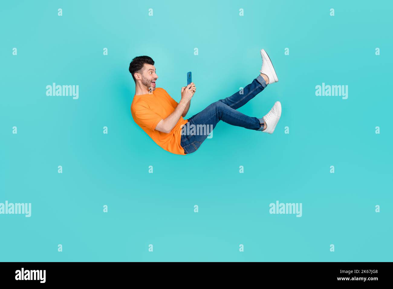 Full body photo of guy blogger falling downward using device incredible ...