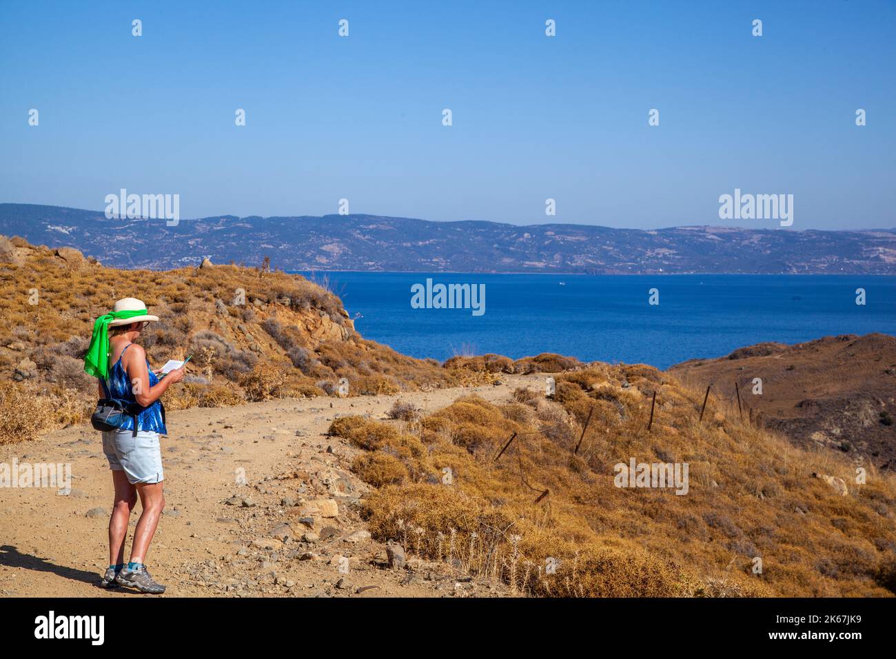 Woman walking in the hills above the Greek holiday resort of Molyvos on ...