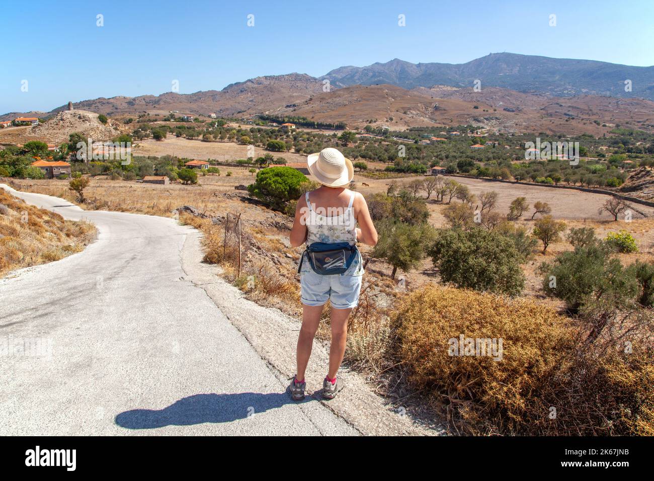 Woman walking in the hills above the Greek holiday resort of Molyvos on ...
