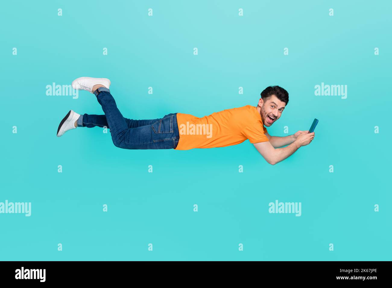 Full size photo of blogger guy flying air using network gadget like ...