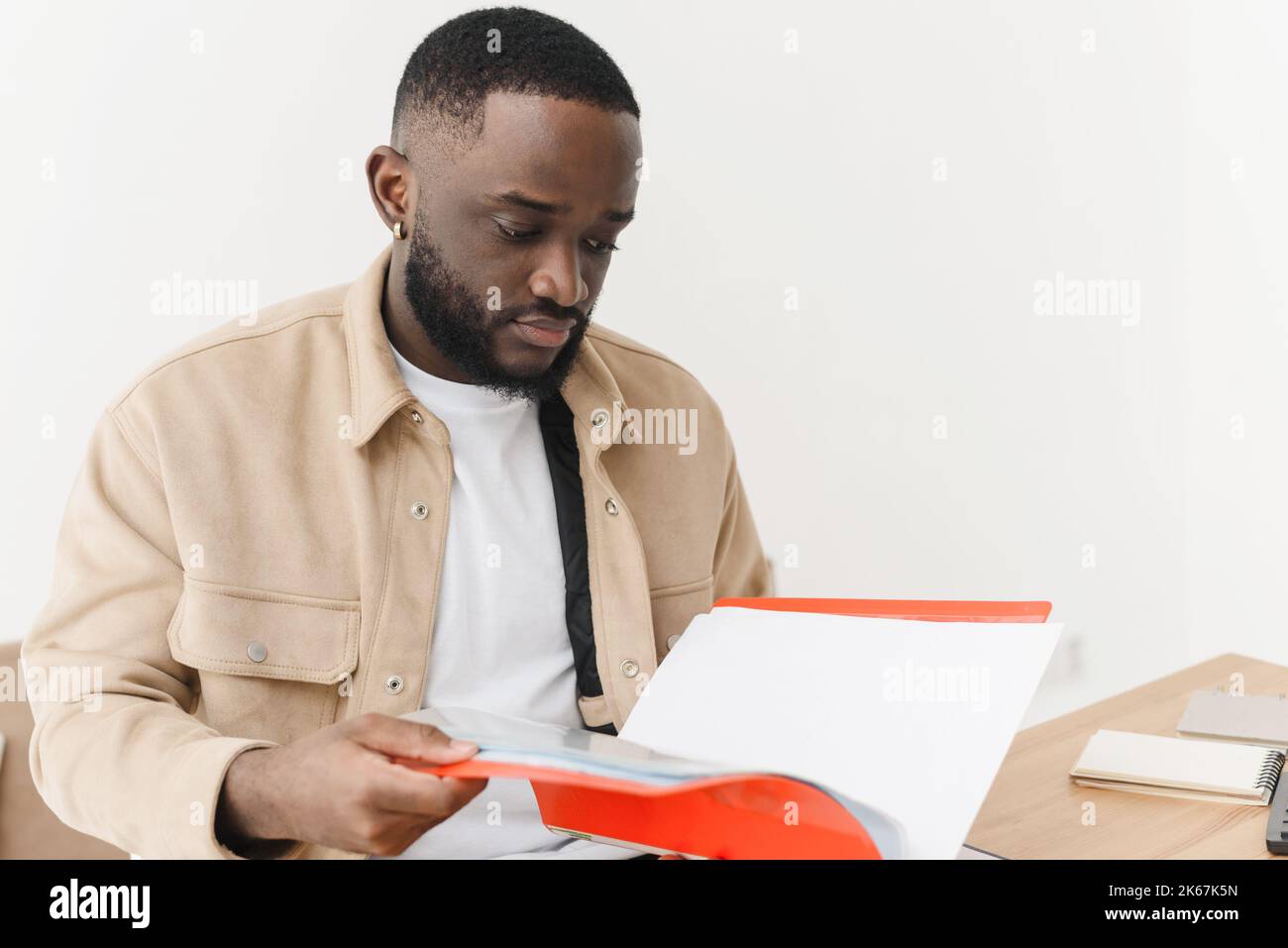 Problems in the household budget during the crisis. Young black sad man ...