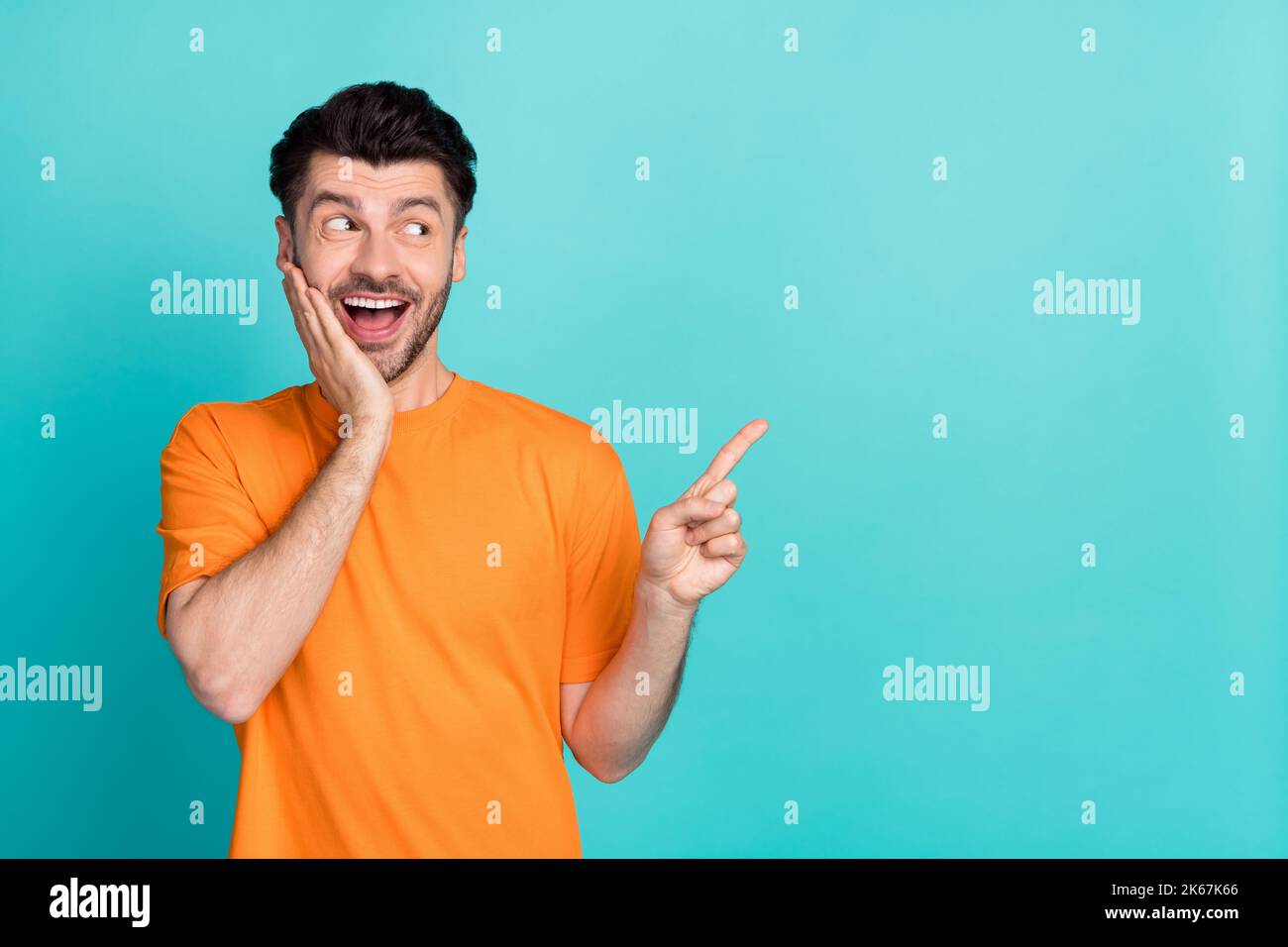 Portrait Photo Of Young Handsome Funny Guy Wear Orange T Shirt Touch