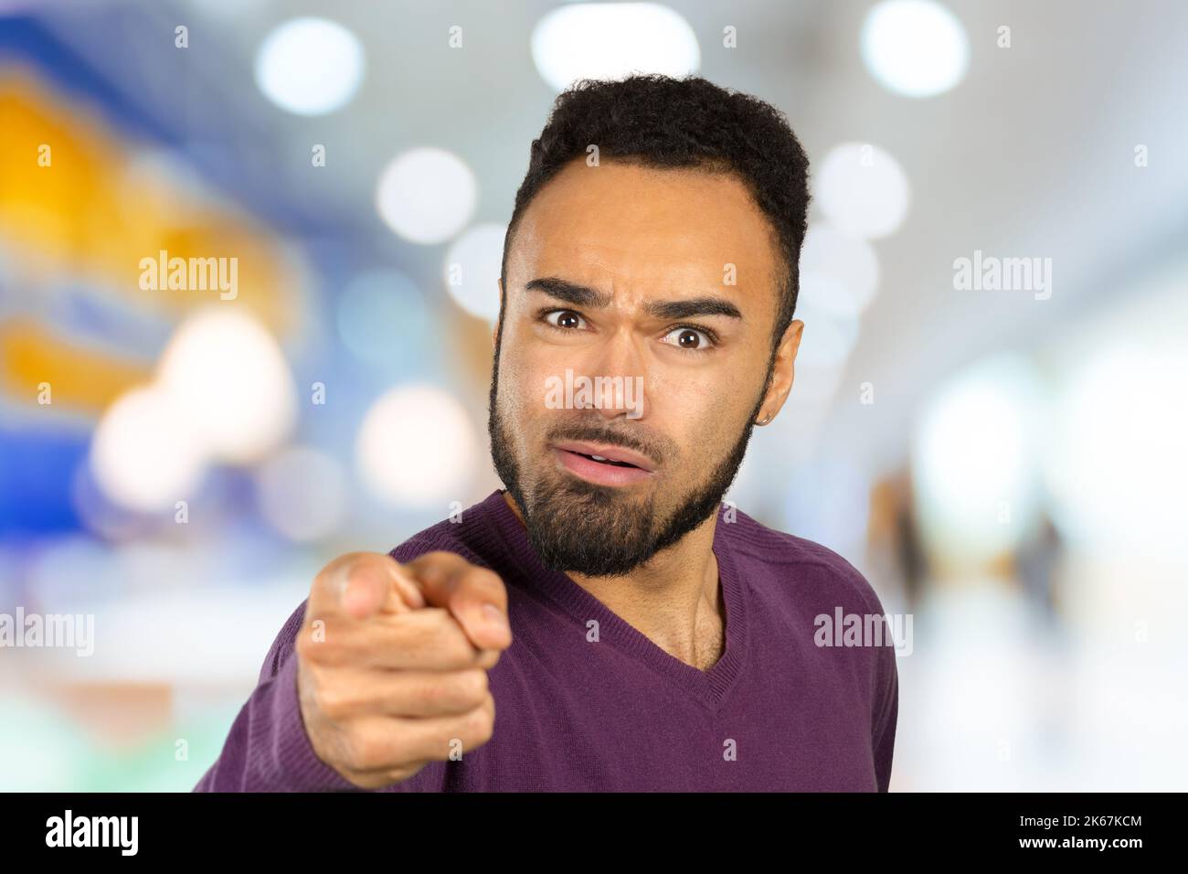 Photo of emotional angry young african man standing isolated Stock ...