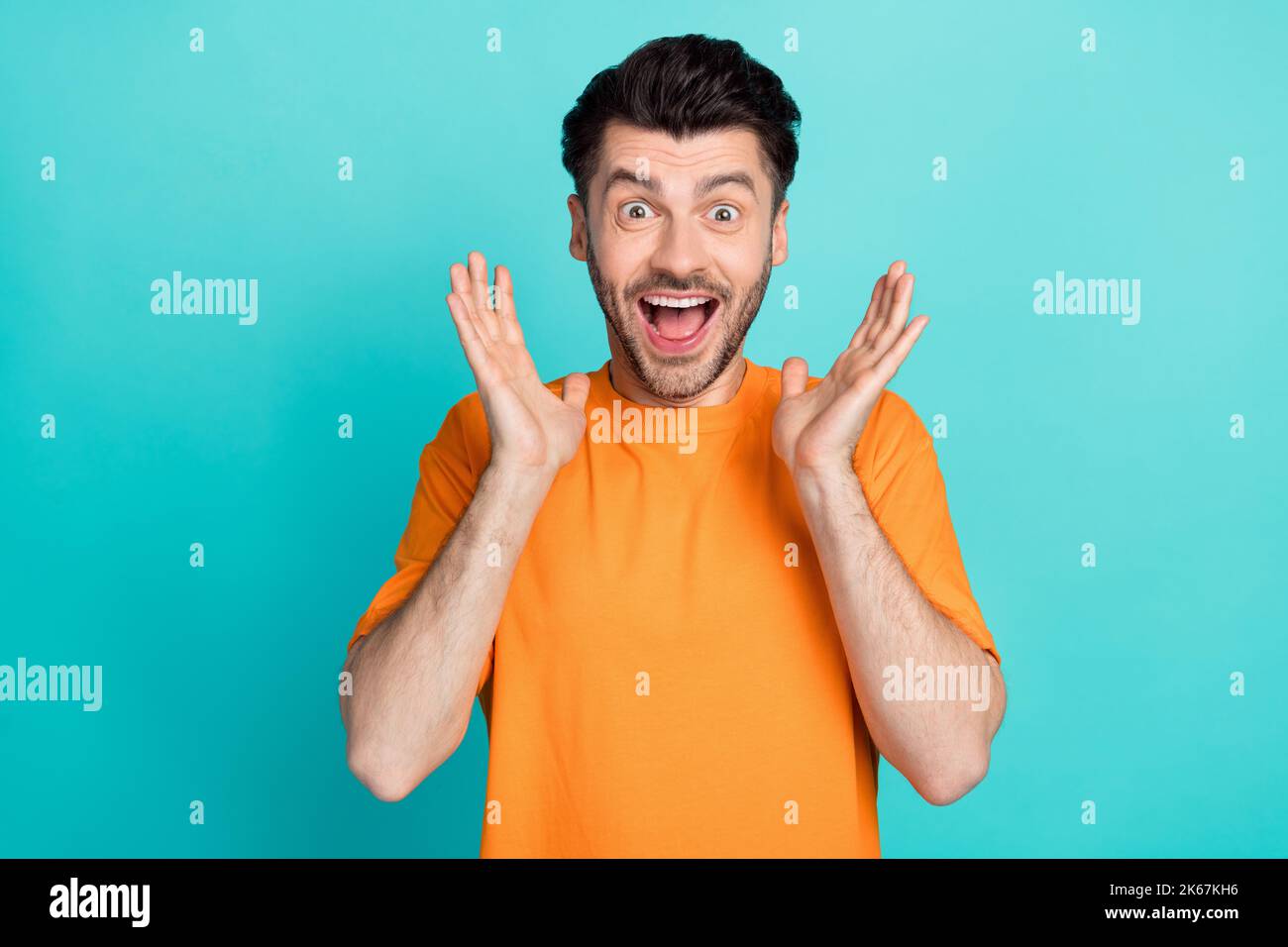 Photo of young attractive handsome excited positive bearded man hands palms shock reaction ...