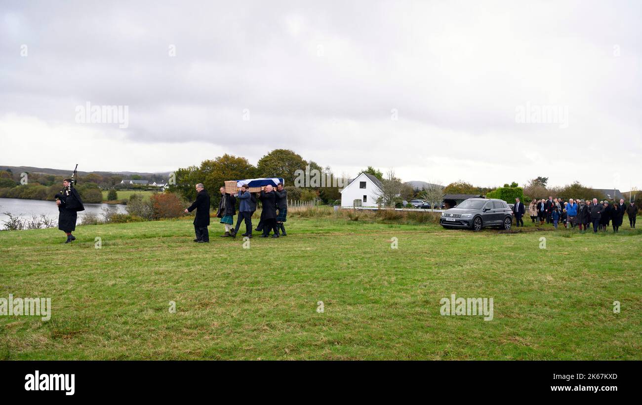 Mourners carrying the coffin of Ian Hamilton KC to his burial in a plot ...