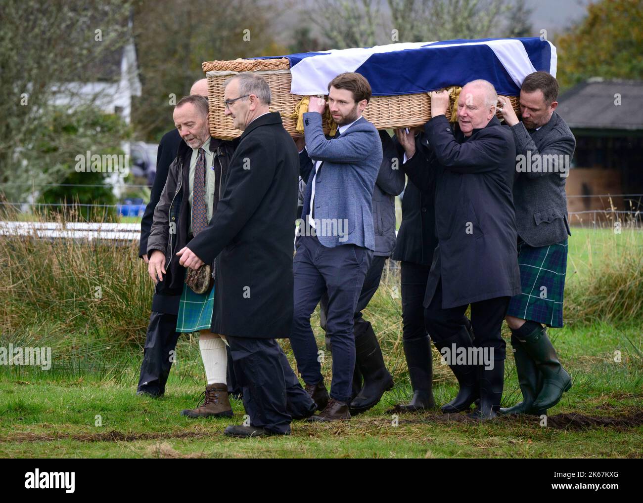 Mourners carrying the coffin of Ian Hamilton KC to his burial in a plot ...