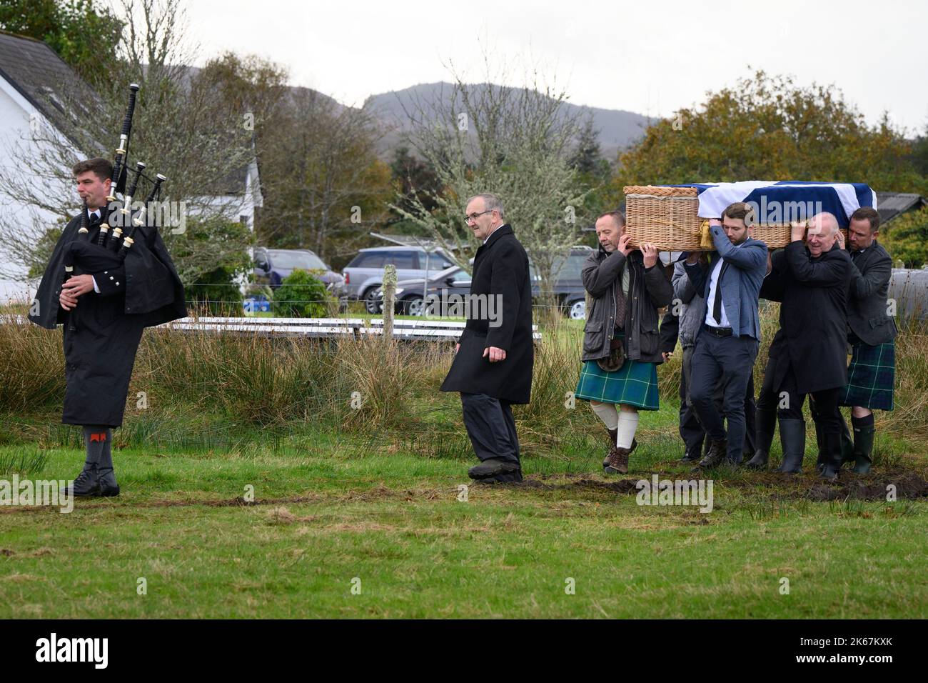 Mourners carrying the coffin of Ian Hamilton KC to his burial in a plot ...