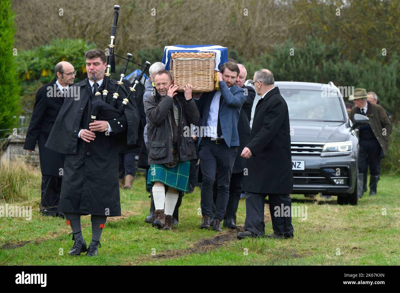 Mourners carrying the coffin of Ian Hamilton KC to his burial in a plot ...