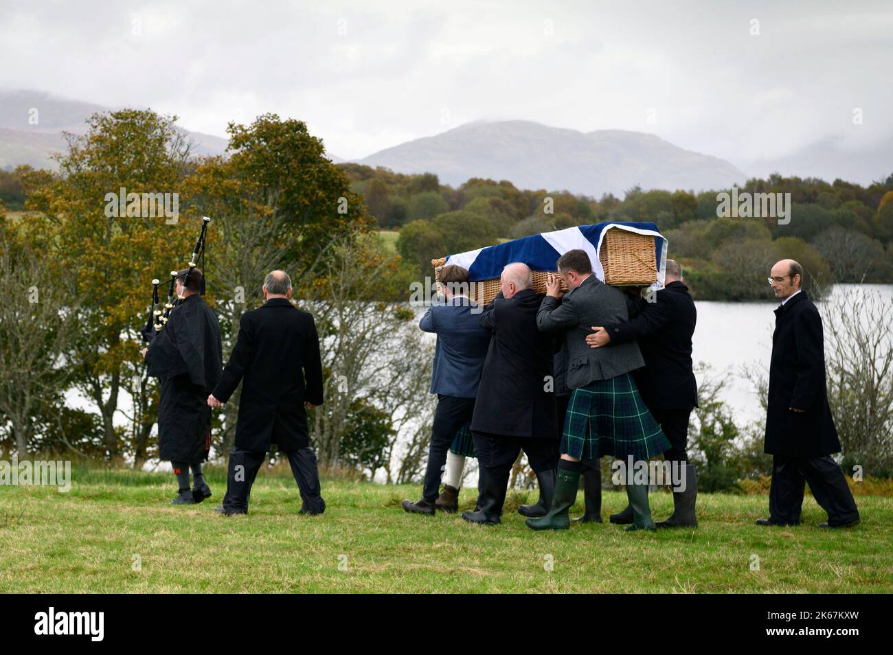 Mourners carrying the coffin of Ian Hamilton KC to his burial in a plot ...