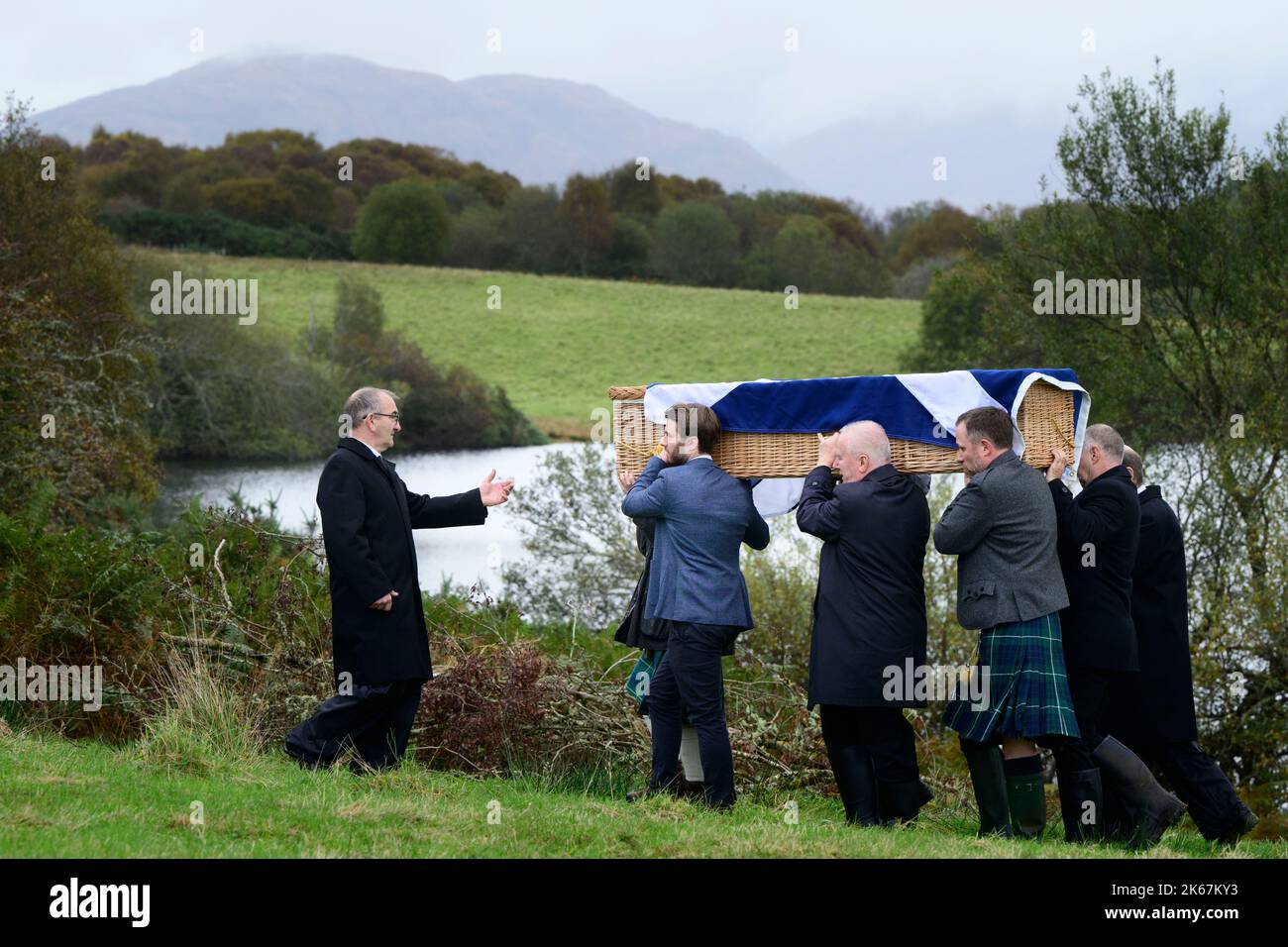 Mourners carrying the coffin of Ian Hamilton KC to his burial in a plot ...