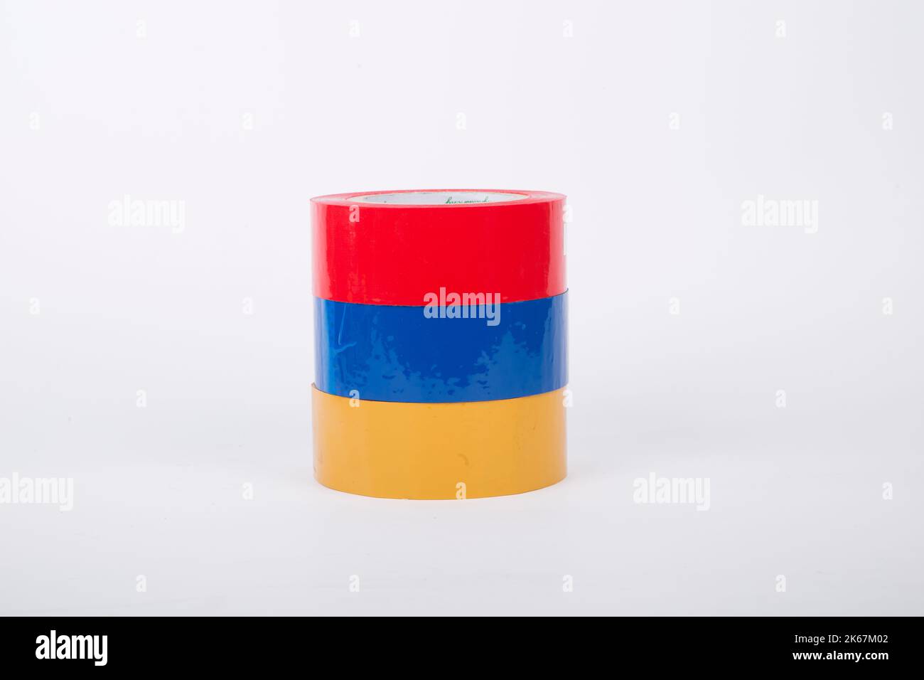 A three colored adhesive tapes on each other vertically isolated on ...