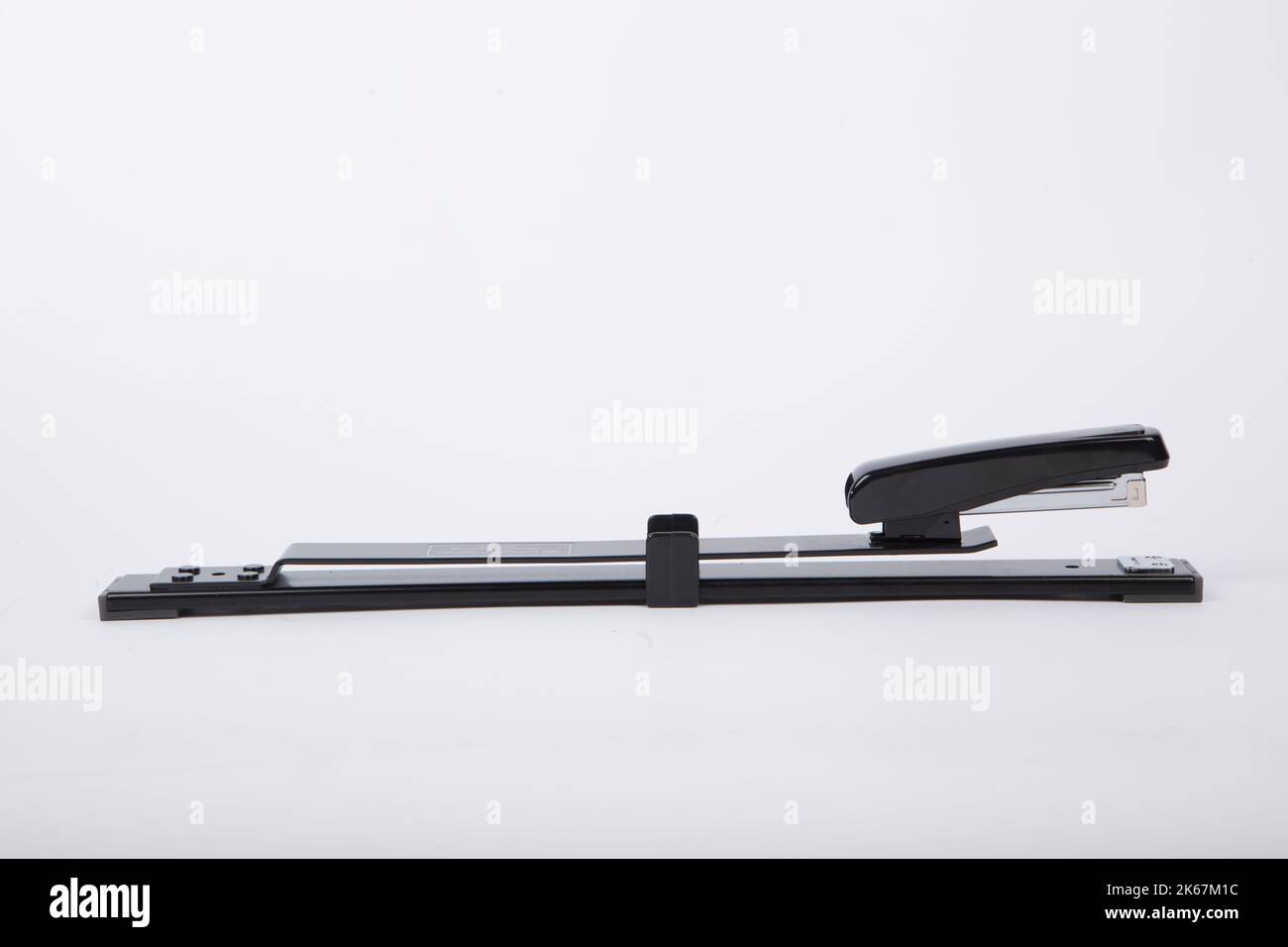 A manual long arm stapler isolated on white background Stock Photo - Alamy