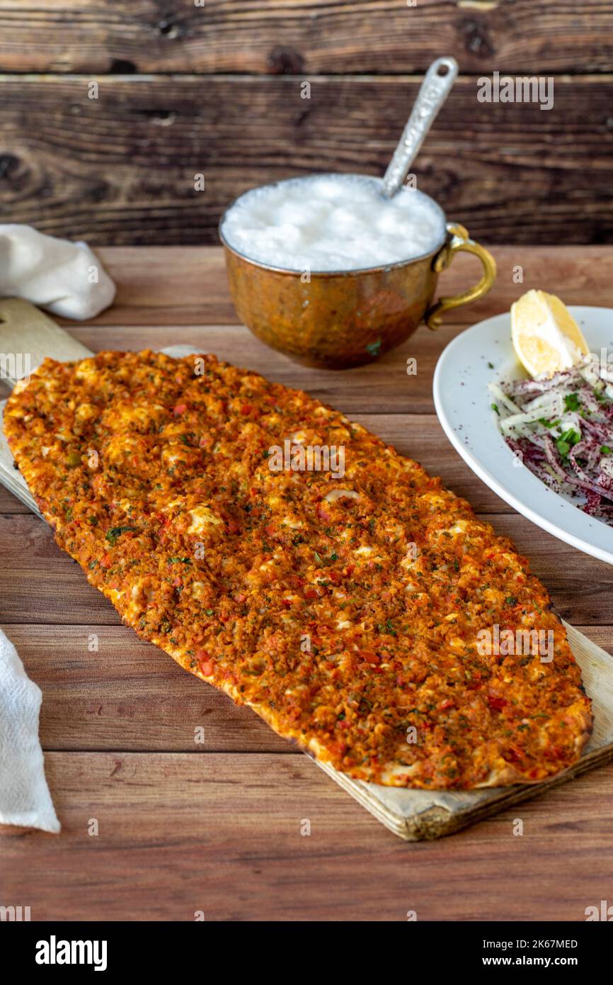 Lahmacun or Turkish pizza with minced meat on a wood background ...