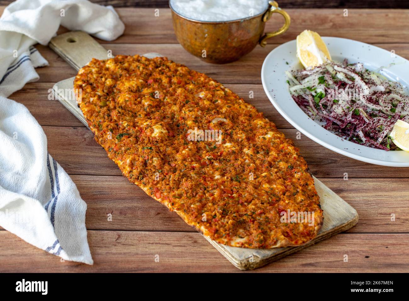 Lahmacun or Turkish pizza with minced meat on a wood background ...