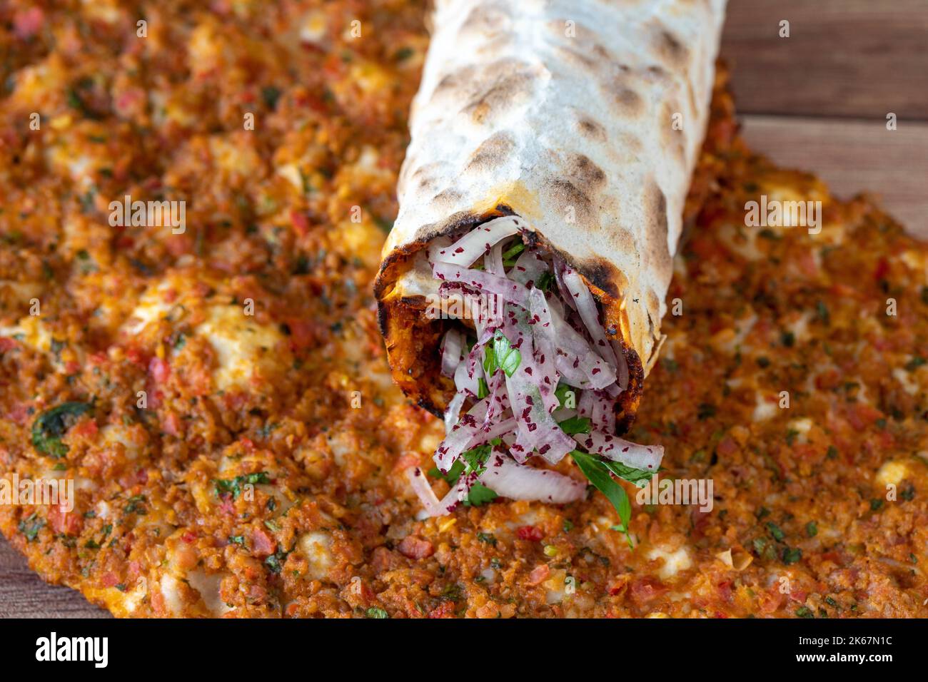 Lahmacun or Turkish pizza with minced meat on a wood background ...