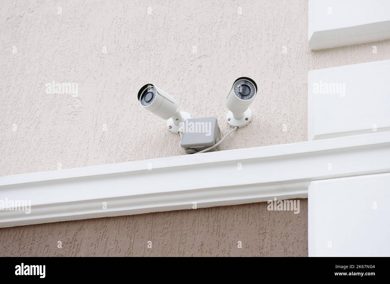 Two CCTV security cameras on the wall of the facade of the house Stock ...