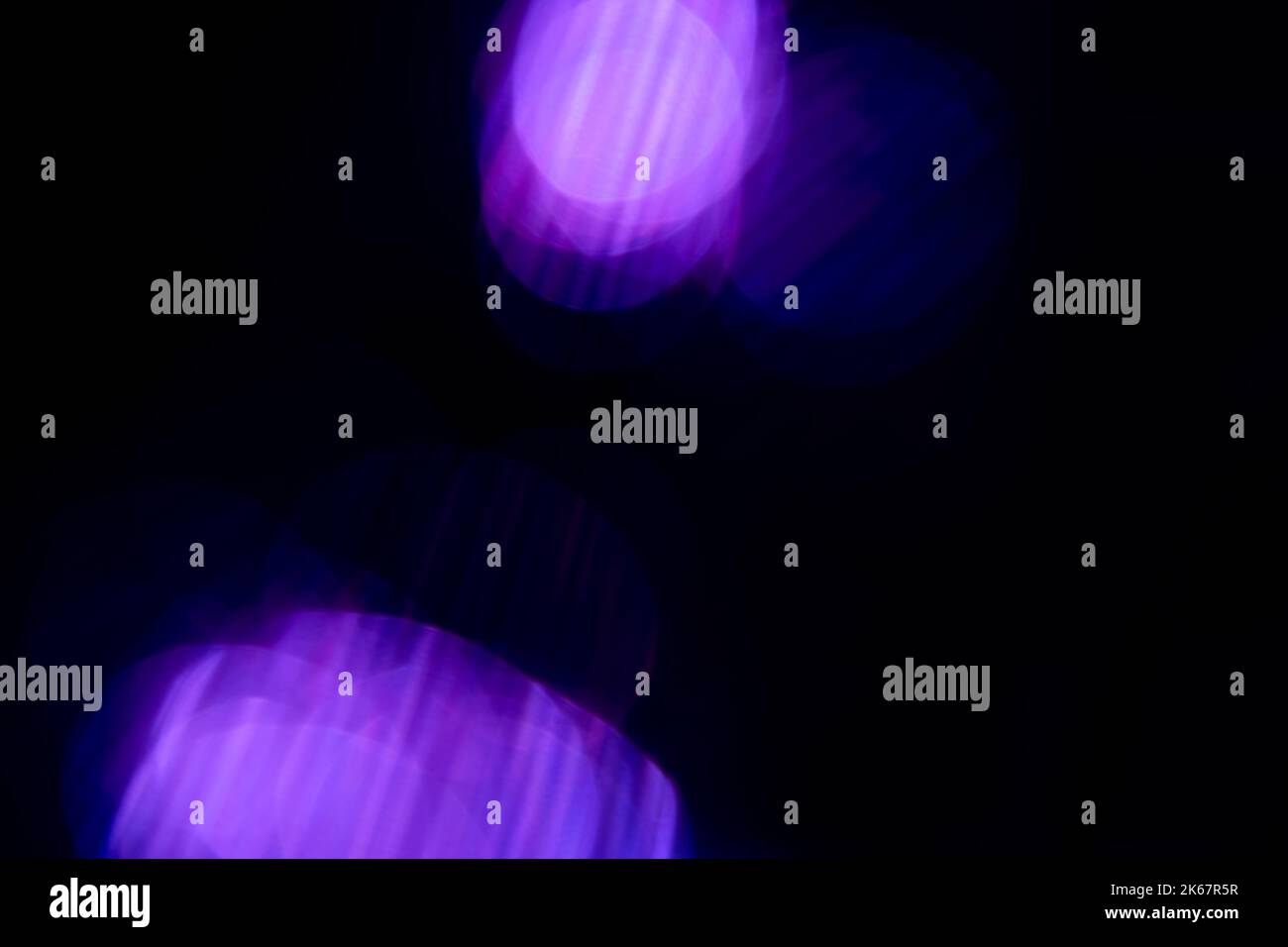 purple rainbow crystal light leaks on black background Stock Photo - Alamy