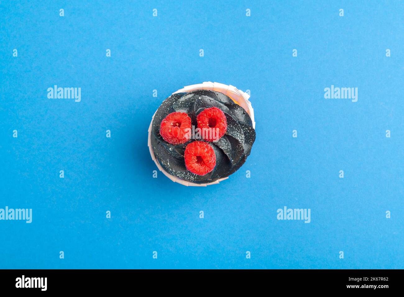 Birthday cupcakes on blue background close up Stock Photo - Alamy