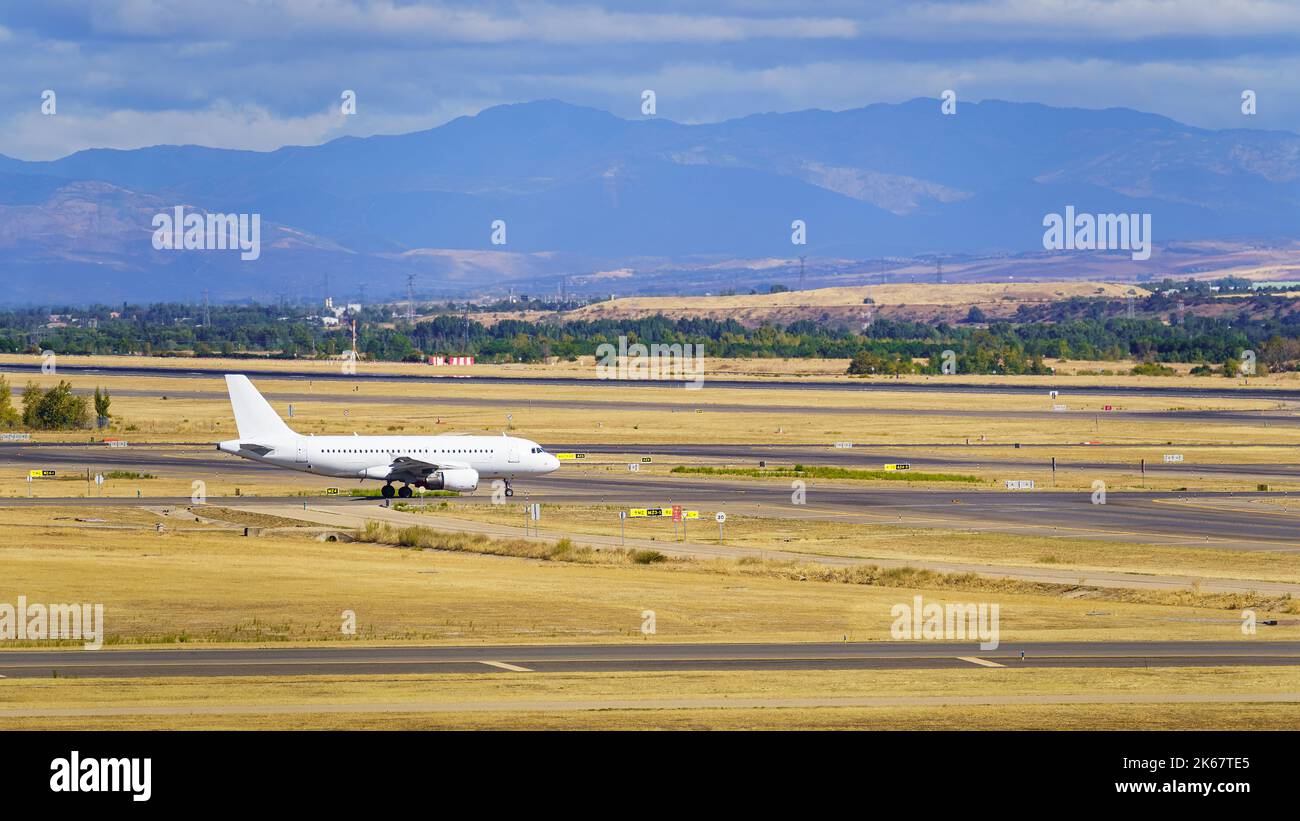 Generic plane rolling along the slope next to some high mountains ...