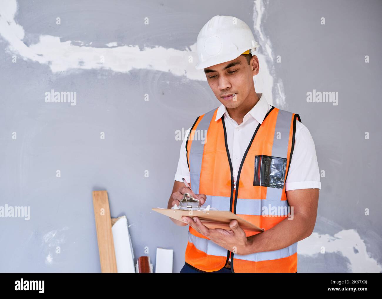 A construction supervisor checks renovation project with checklist on ...