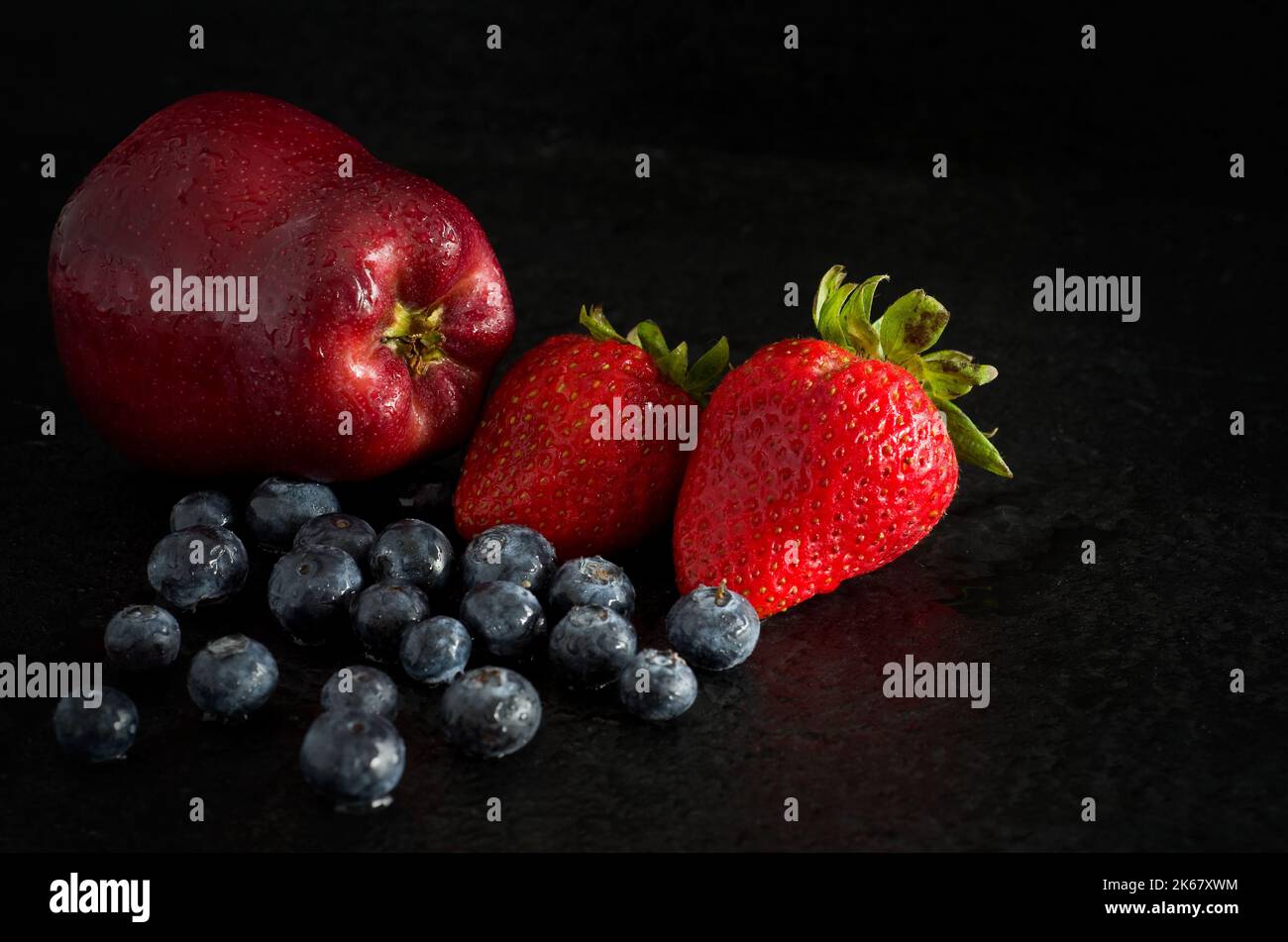Delicious Red Apple, Strawberries and Blueberries on Dark Background ...
