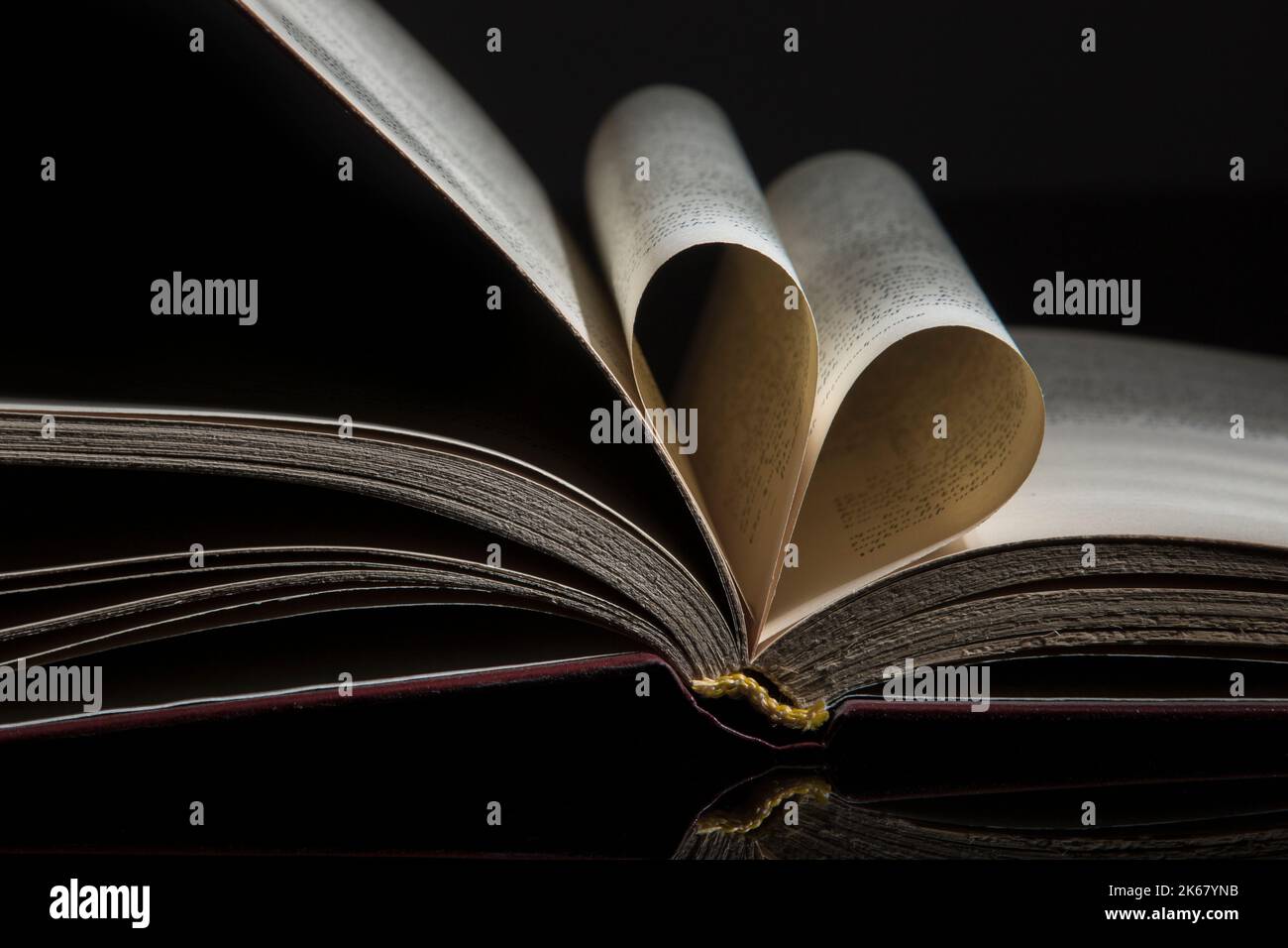 Open book with shape heart Stock Photo - Alamy