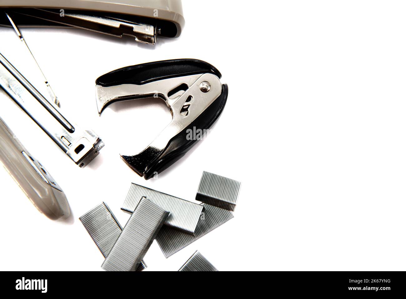 Stapler and anti-stapler with staples on a white background. Office ...