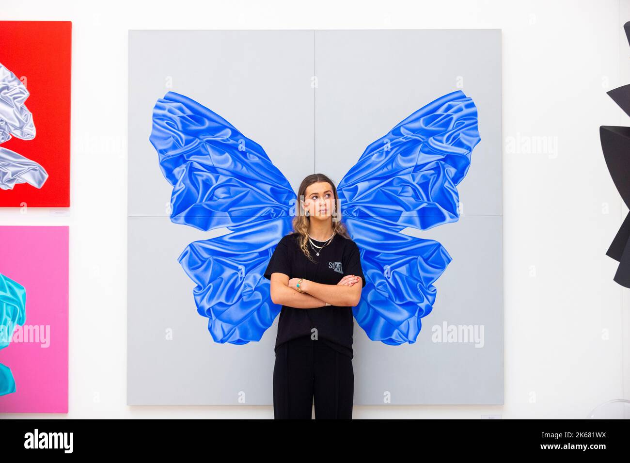 London, UK. 12 October 2022. A staff member with 'Morpho' by Ana Elisa ...