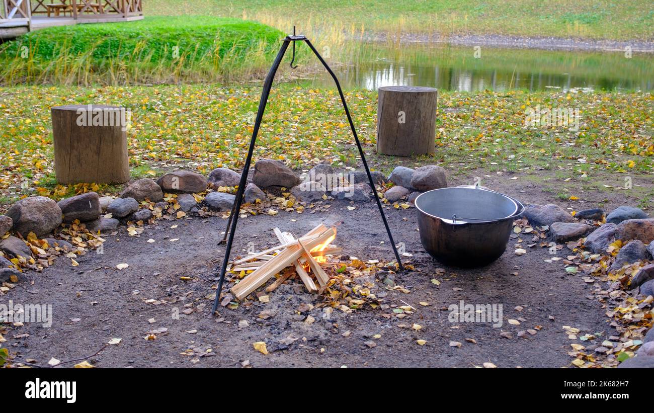 Cooking in a pot on an open fire in nature. Bowler on a bonfire in the ...